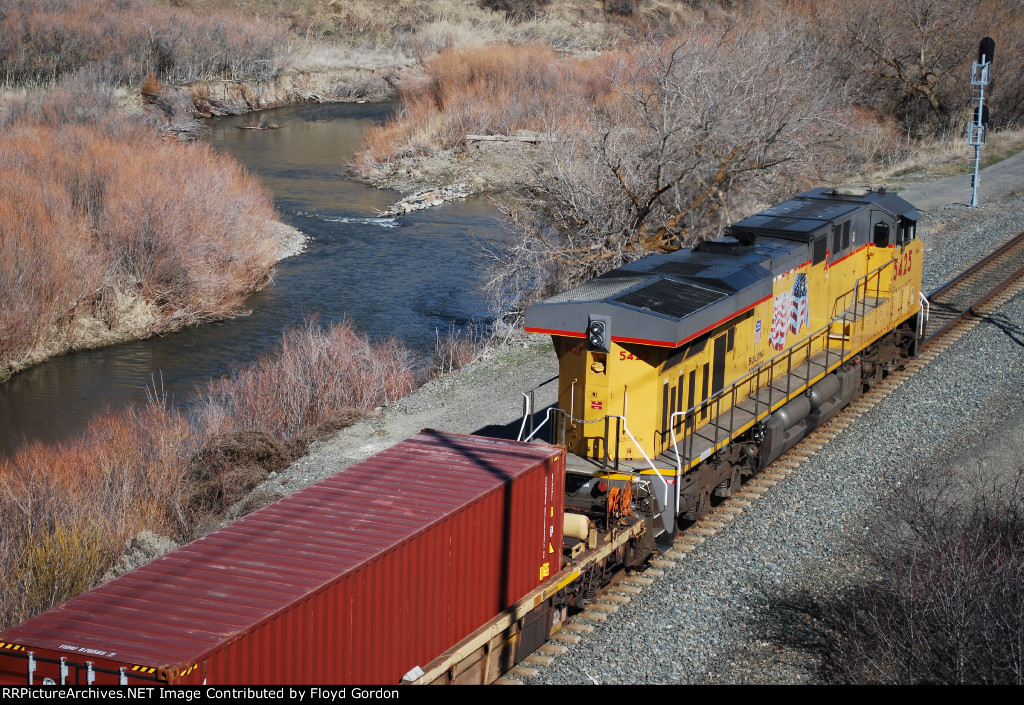 UP 5425 pushes a west bound double stack along Burnt River